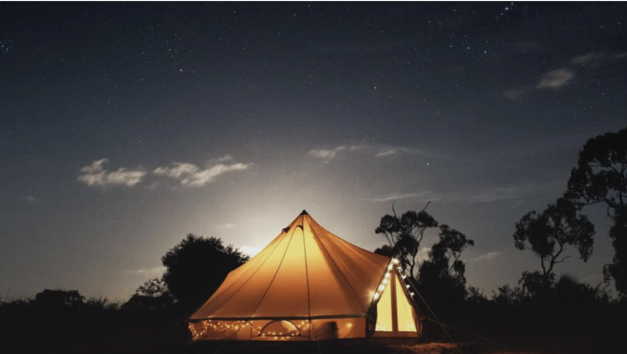 Summer Glamp Bell Tent at Night - VIP Magazine